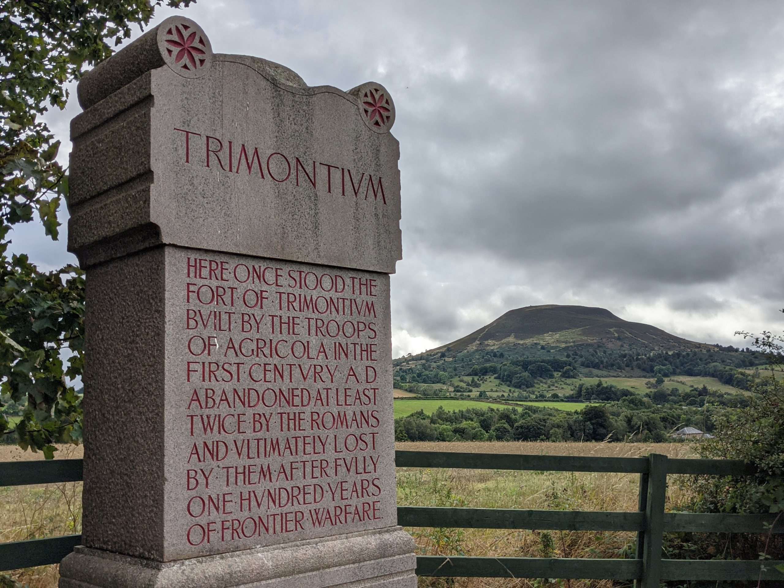 Monument at the site of Trimontium Roman fort, with the native hillfort ...