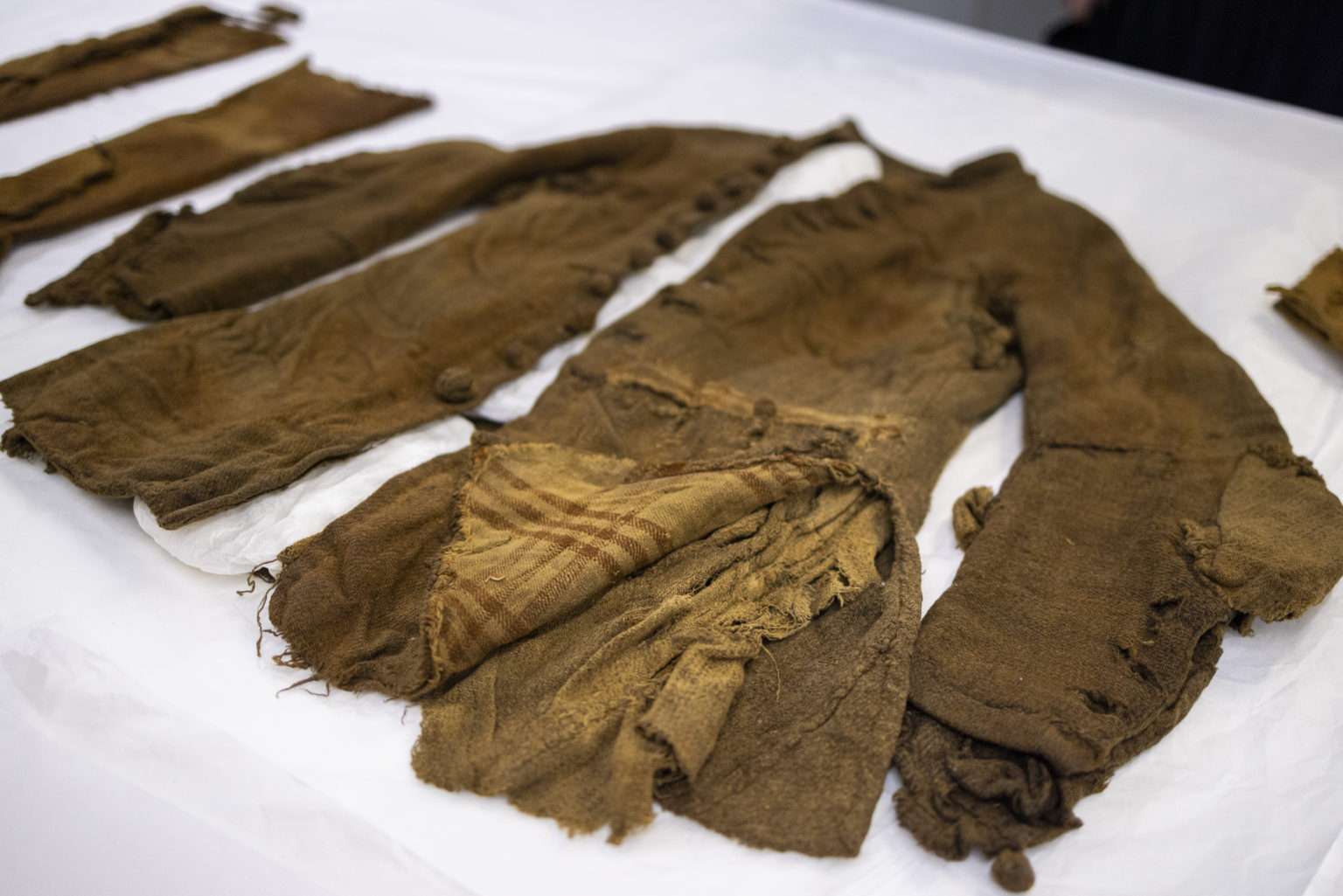 Curators examine clothing discovered on Kinloch Moor, 18th century ...